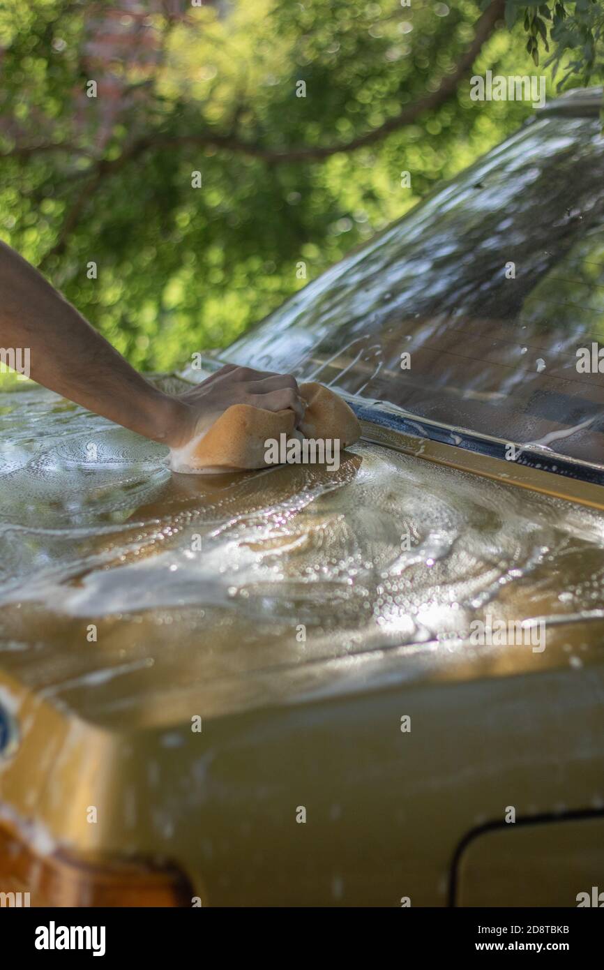 A young men washing an old vintage car Stock Photo - Alamy