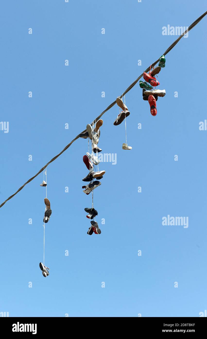 Shoes hanging from light hi-res stock photography and images - Alamy