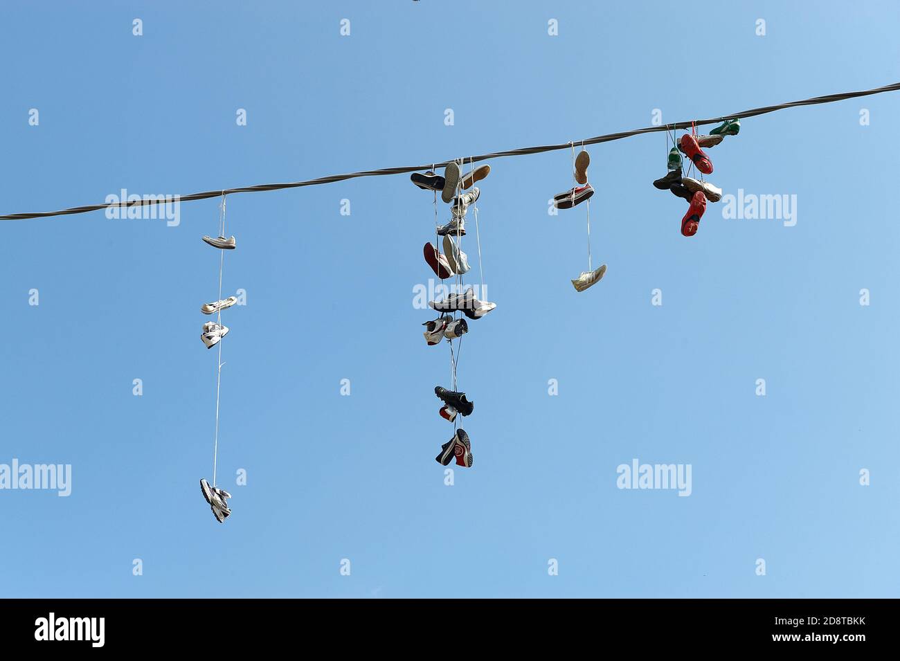 Shoes hanging from light hi-res stock photography and images - Alamy