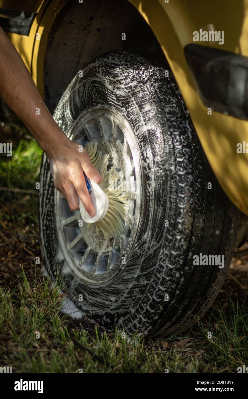 A young men washing an old vintage car Stock Photo - Alamy