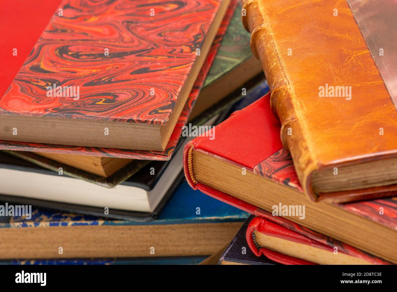 Two stacks of old books with ancient bindings Stock Photo - Alamy