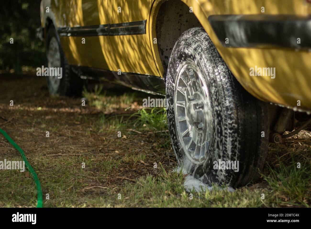 A young men washing an old vintage car Stock Photo - Alamy