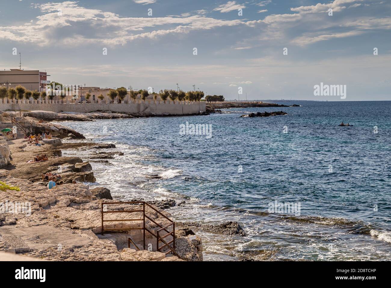 people sunbathing on the rocks in Italy Stock Photo - Alamy