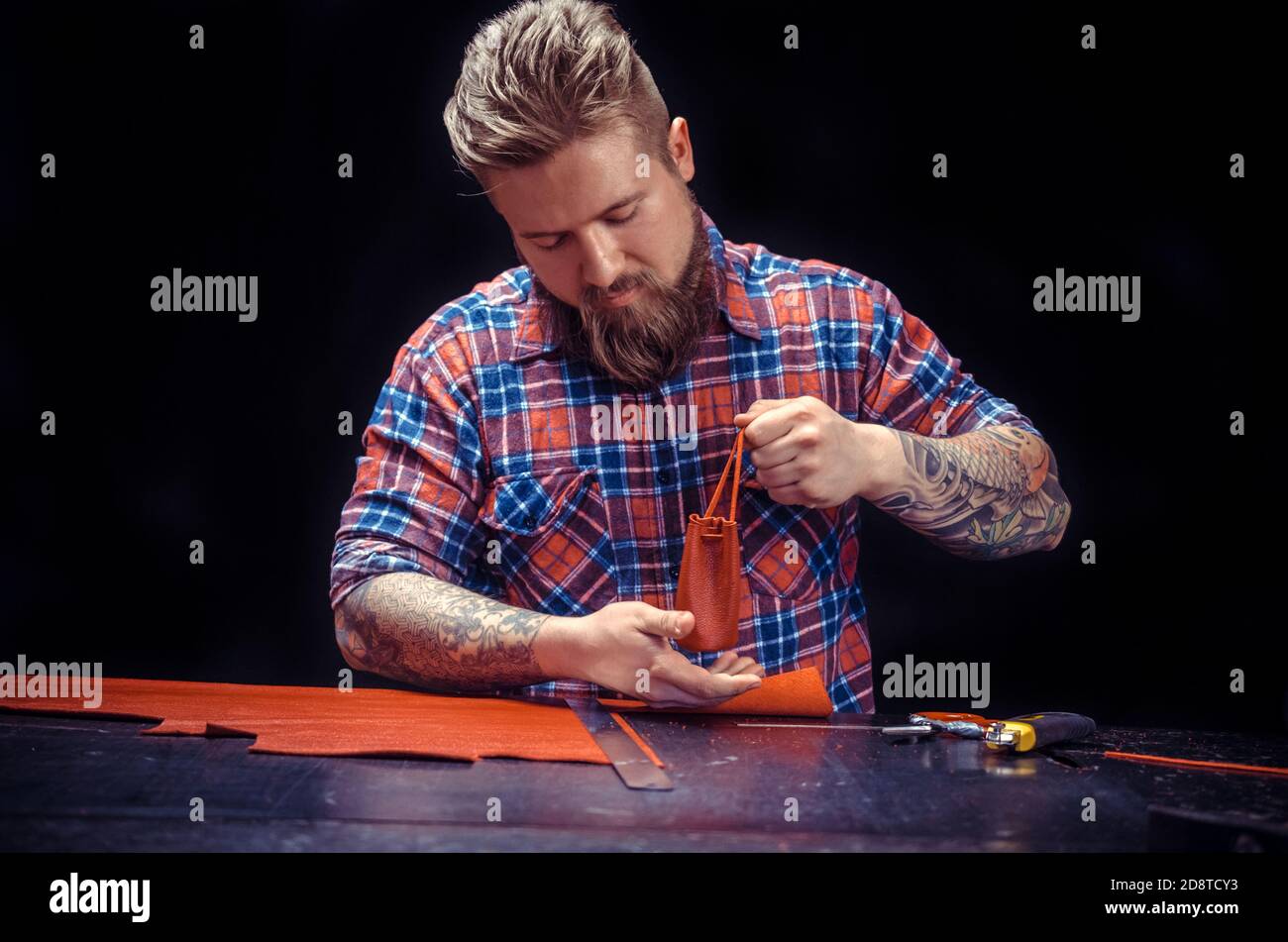 Leather Currier works with leather at the work area Stock Photo - Alamy
