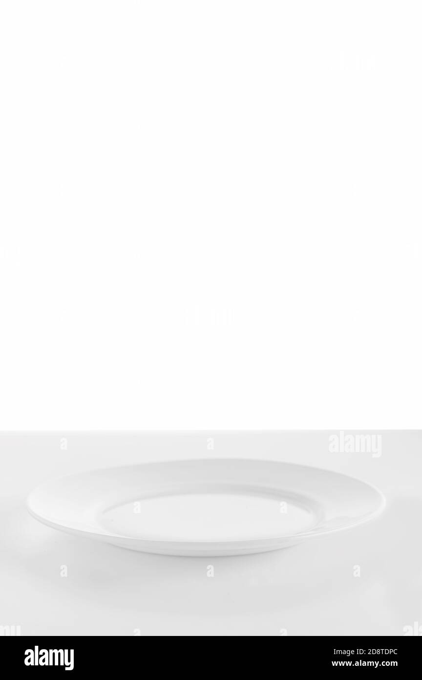 Empty white plate on a white background. Ceramic white plate.Vertical ...