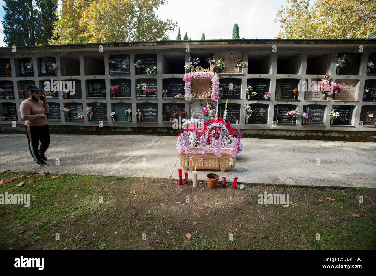 A woman speaking on the telephone in the cemetery during the ...
