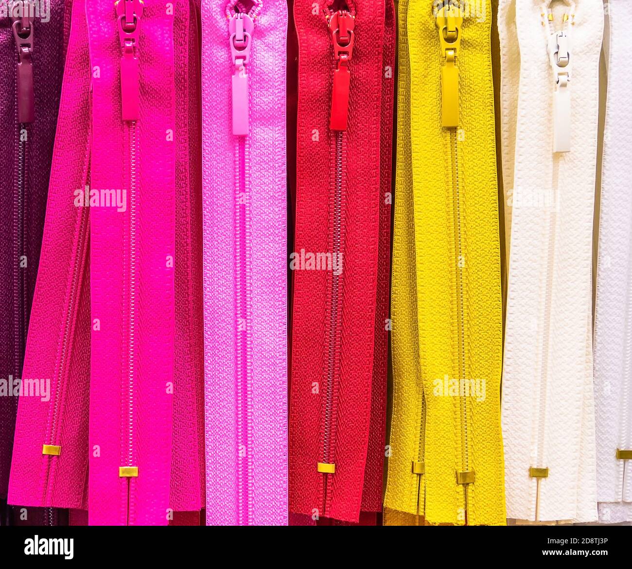 multi-colored zippers for sewing clothes and needlework Stock Photo - Alamy