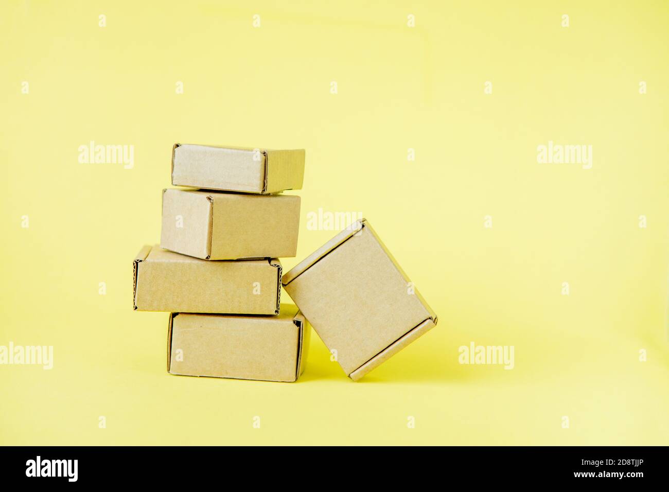 Cardboard boxes of various sizes on yellow background Stock Photo - Alamy