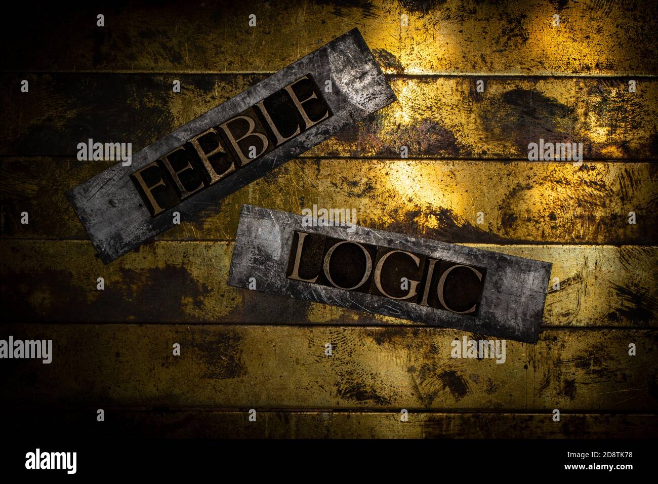 Feeble Logic text on grunge textured copper and gold background Stock ...