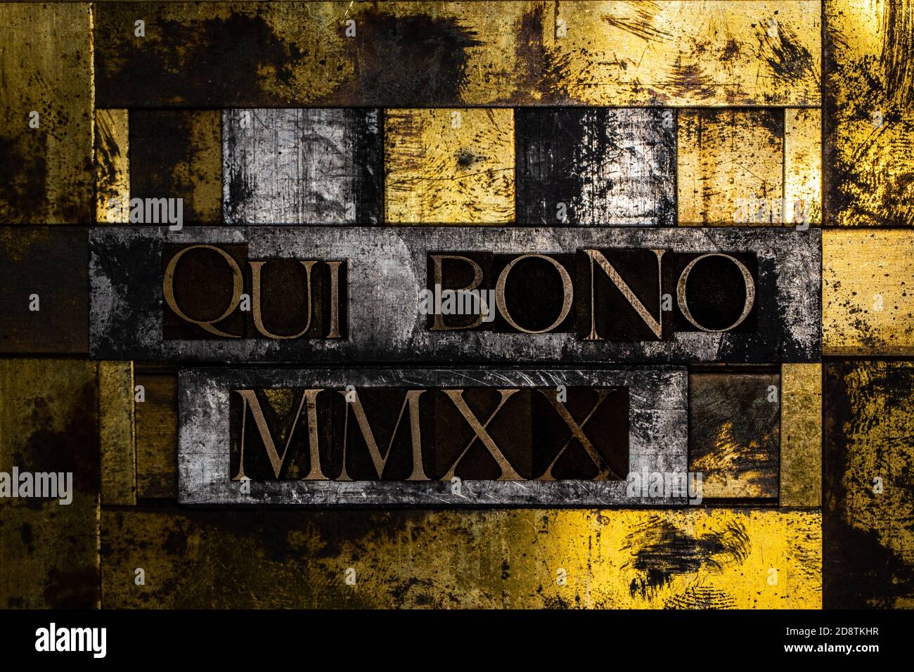 Qui Bono text message on vintage textured gold silver and copper ...