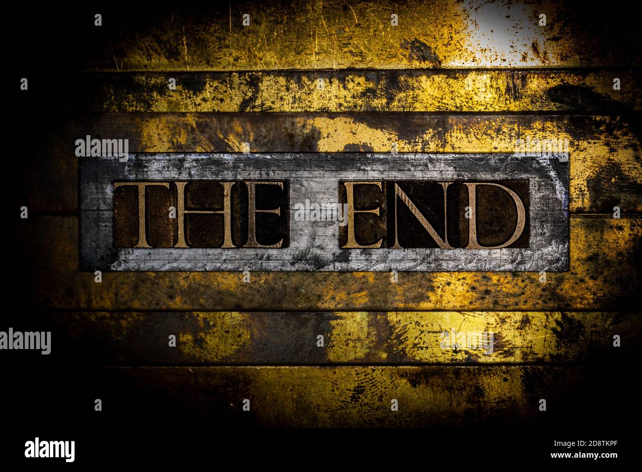 The End text message on textured grunge copper and vintage gold ...