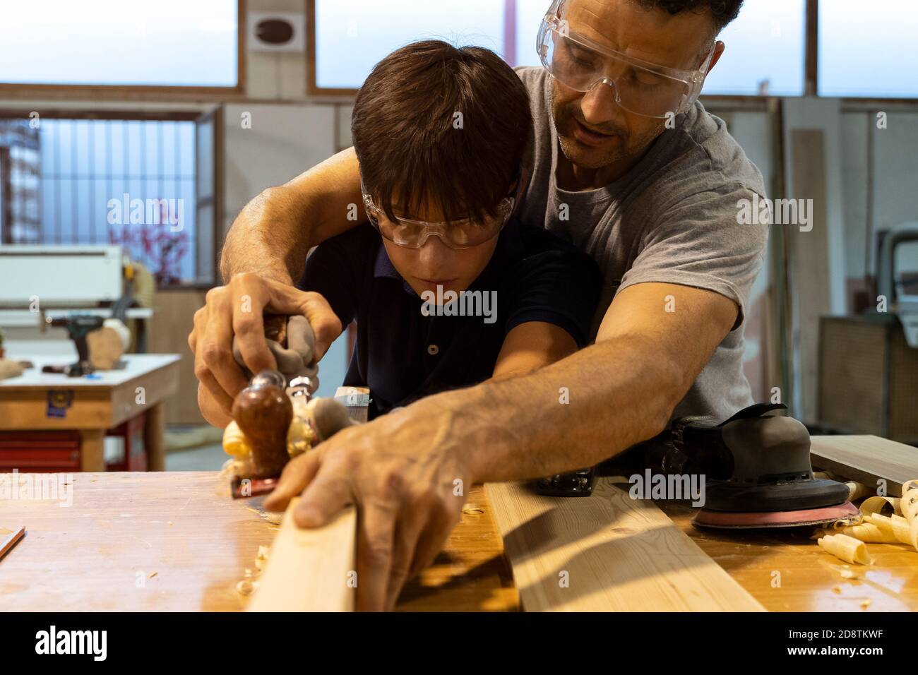 Father son carving together home hi-res stock photography and images ...