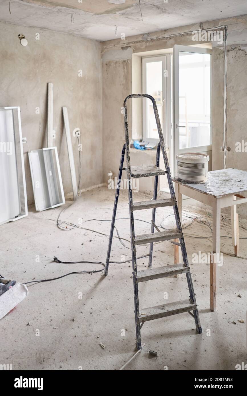 Aluminium ladder in a room under construction works. Repair process in ...