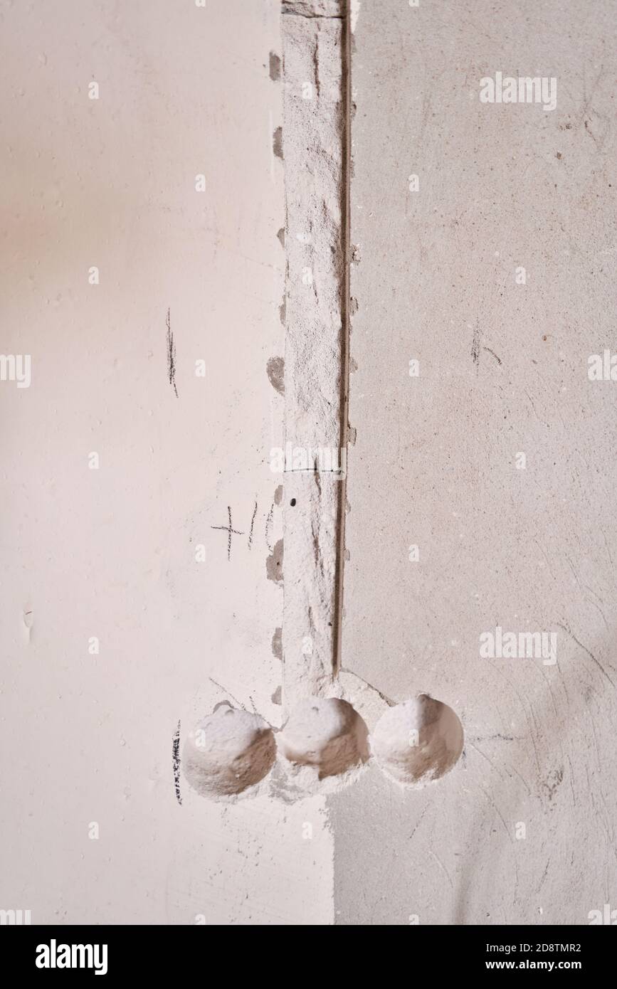 Holes in a concrete wall for installing plastic boxes under sockets ...