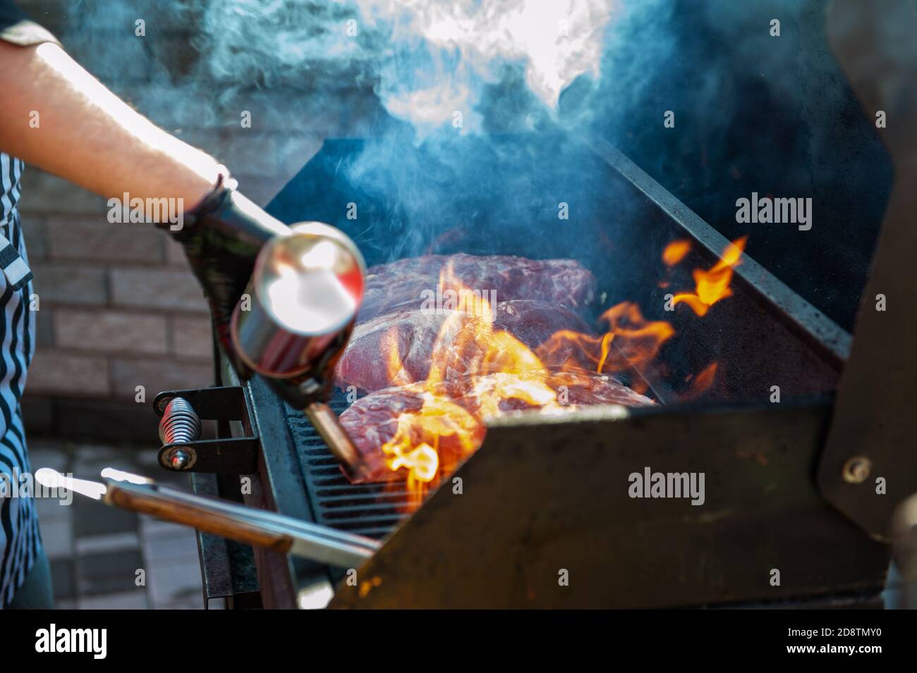 Pork meat steaks on the grill Stock Photo - Alamy