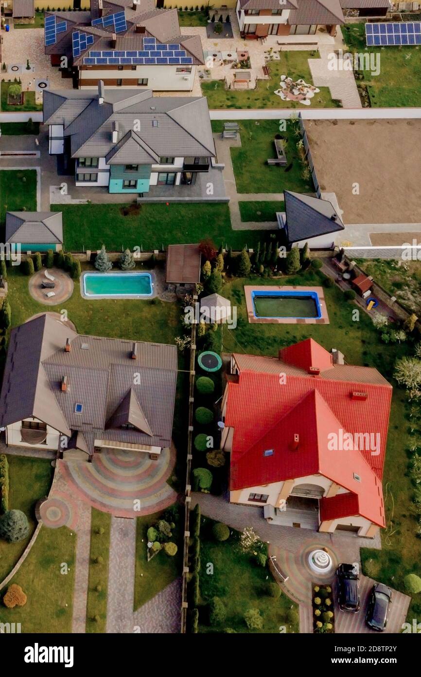 Aerial top view of a house with paved yard with green grass lawn with ...