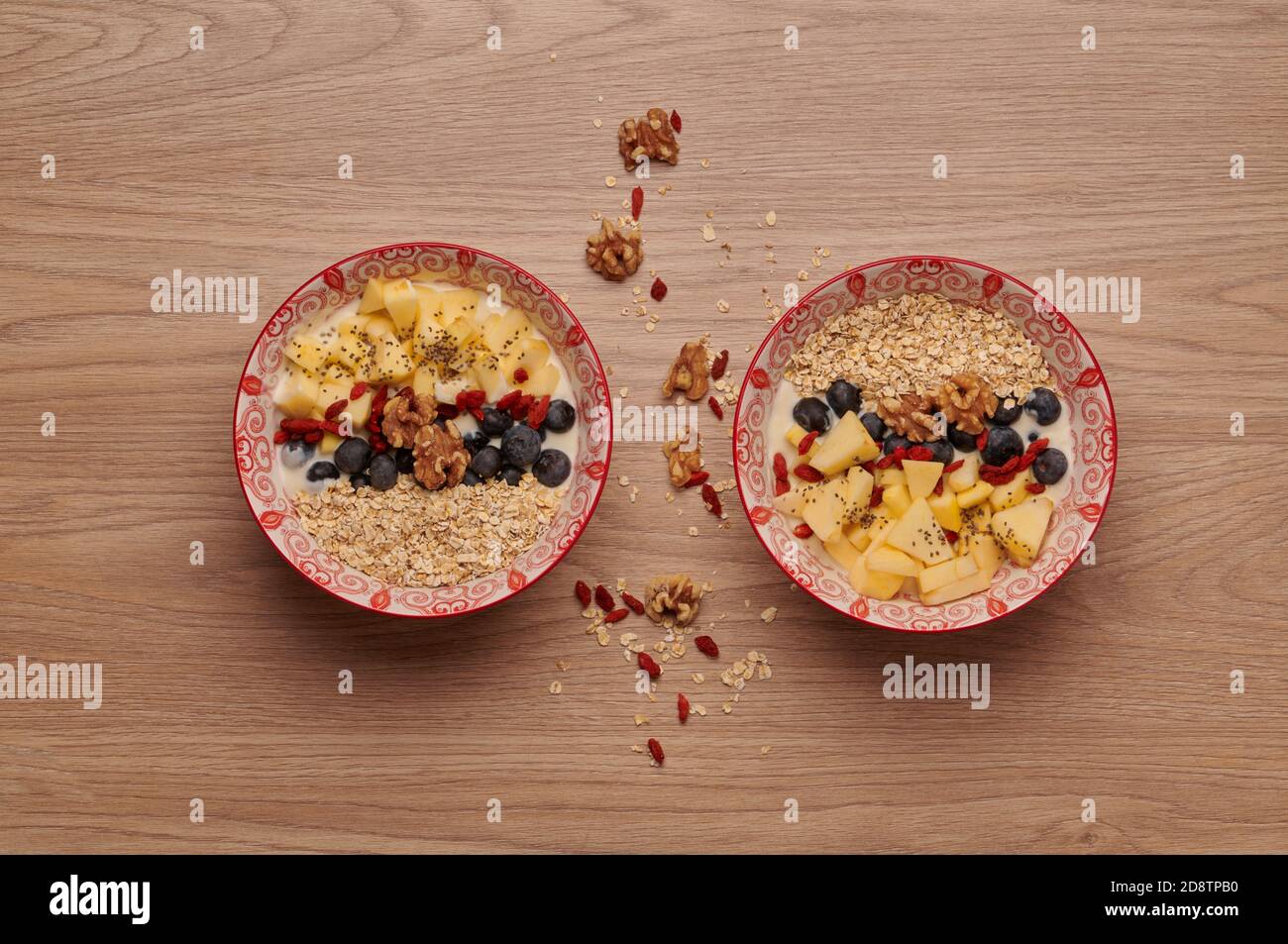Healthy snacks in bowl: yoghurt, oat flakes, apple, blueberries ...