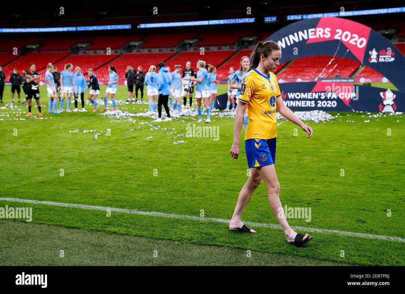Everton's Danielle Turner walks past as Manchester City players ...