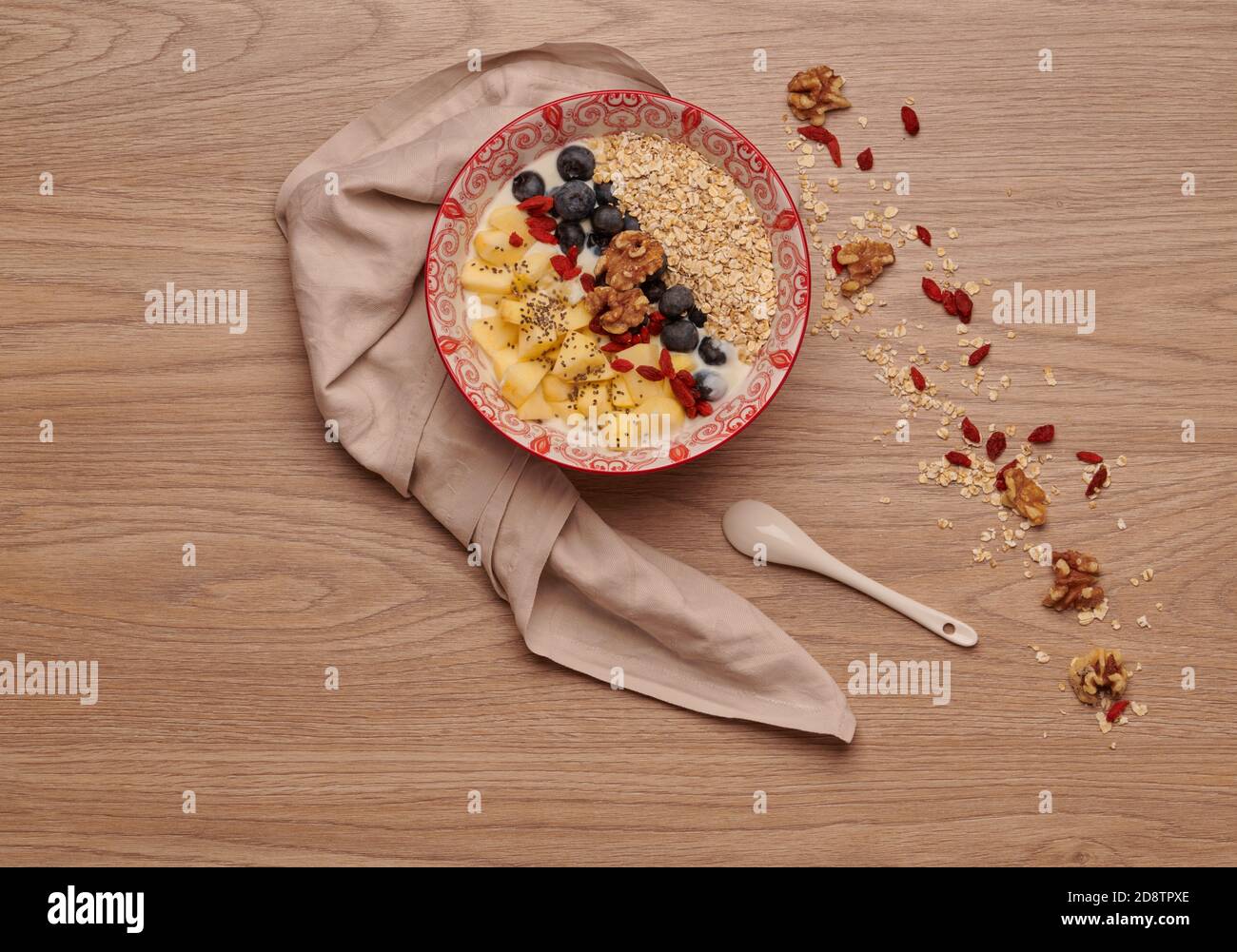 Healthy snacks in bowl: yoghurt, oat flakes, apple, blueberries ...
