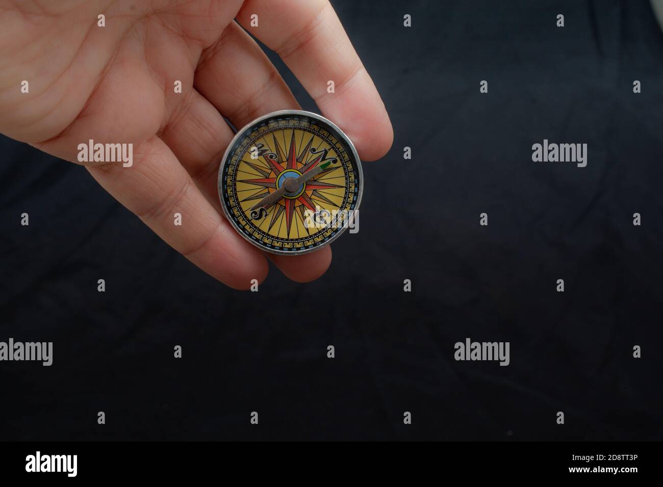 Compass tool in hand o as travel concept Stock Photo - Alamy