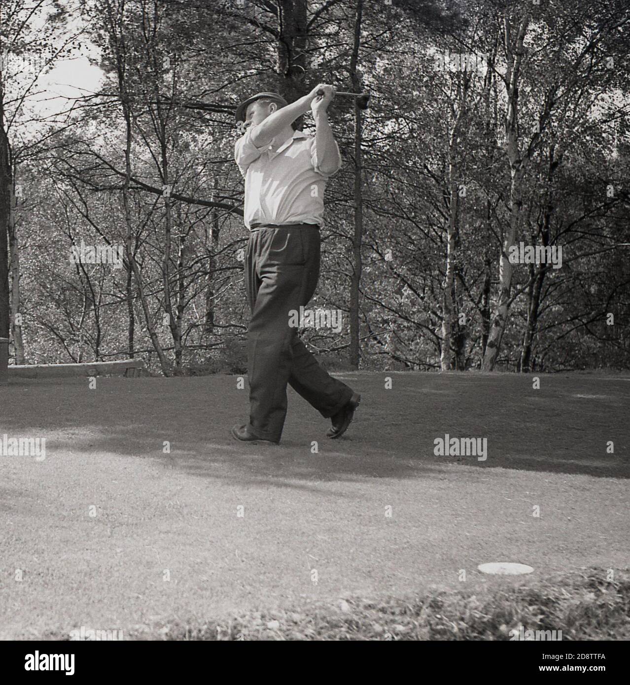 1960s, historical, a male golfer on an inland golf course driving the ...