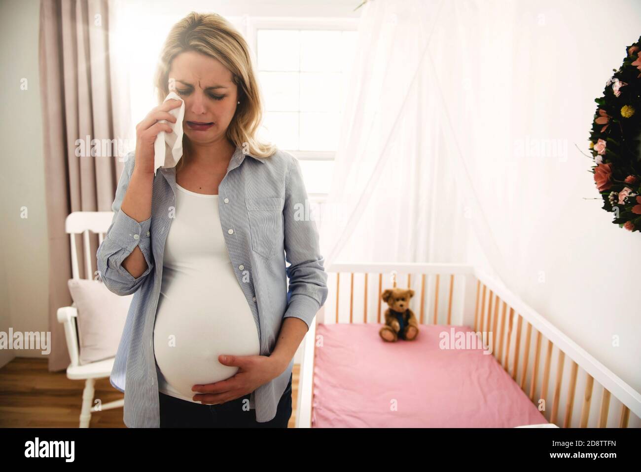 Pregnant woman with a lot of stress at home crying with tissue Stock ...