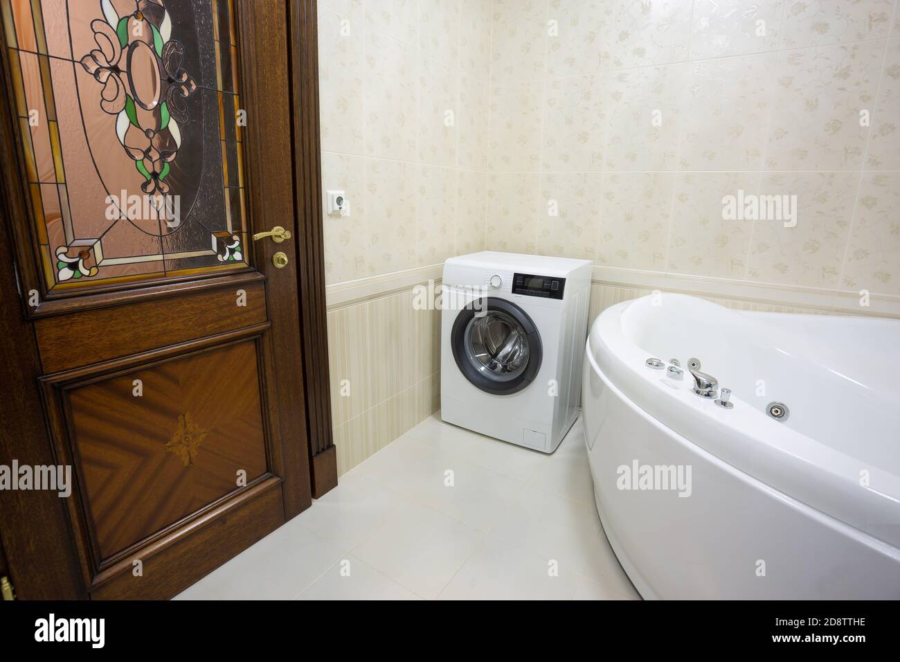 Modern bathroom with jacuzzi bath Stock Photo - Alamy