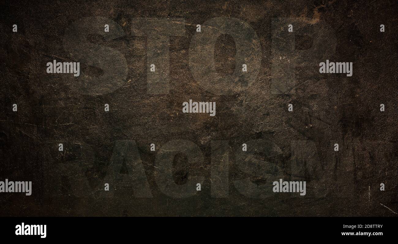 Font with transparency STOP RACISM graffiti on a black stone background ...