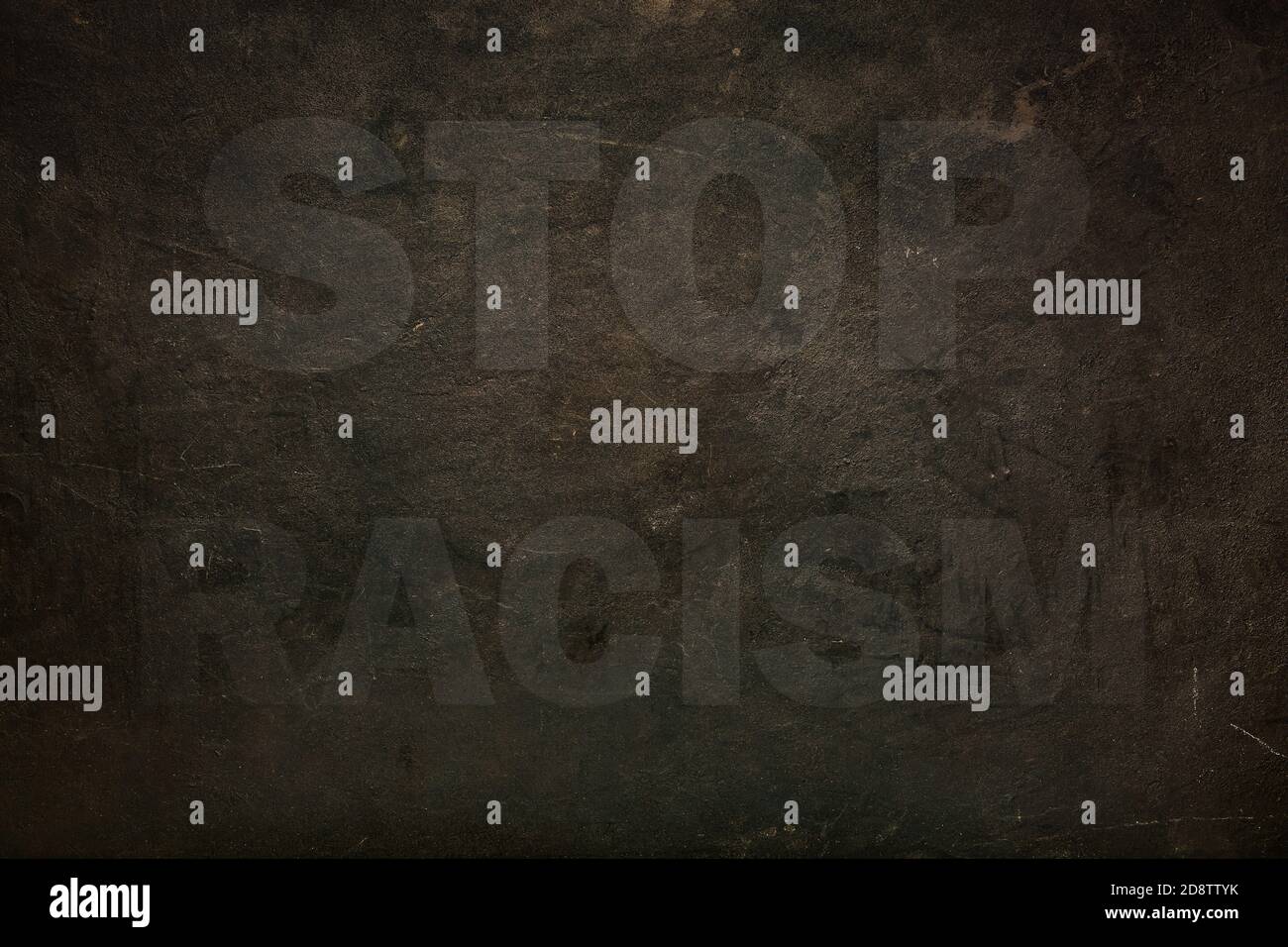 Font with transparency STOP RACISM graffiti on a black stone background ...