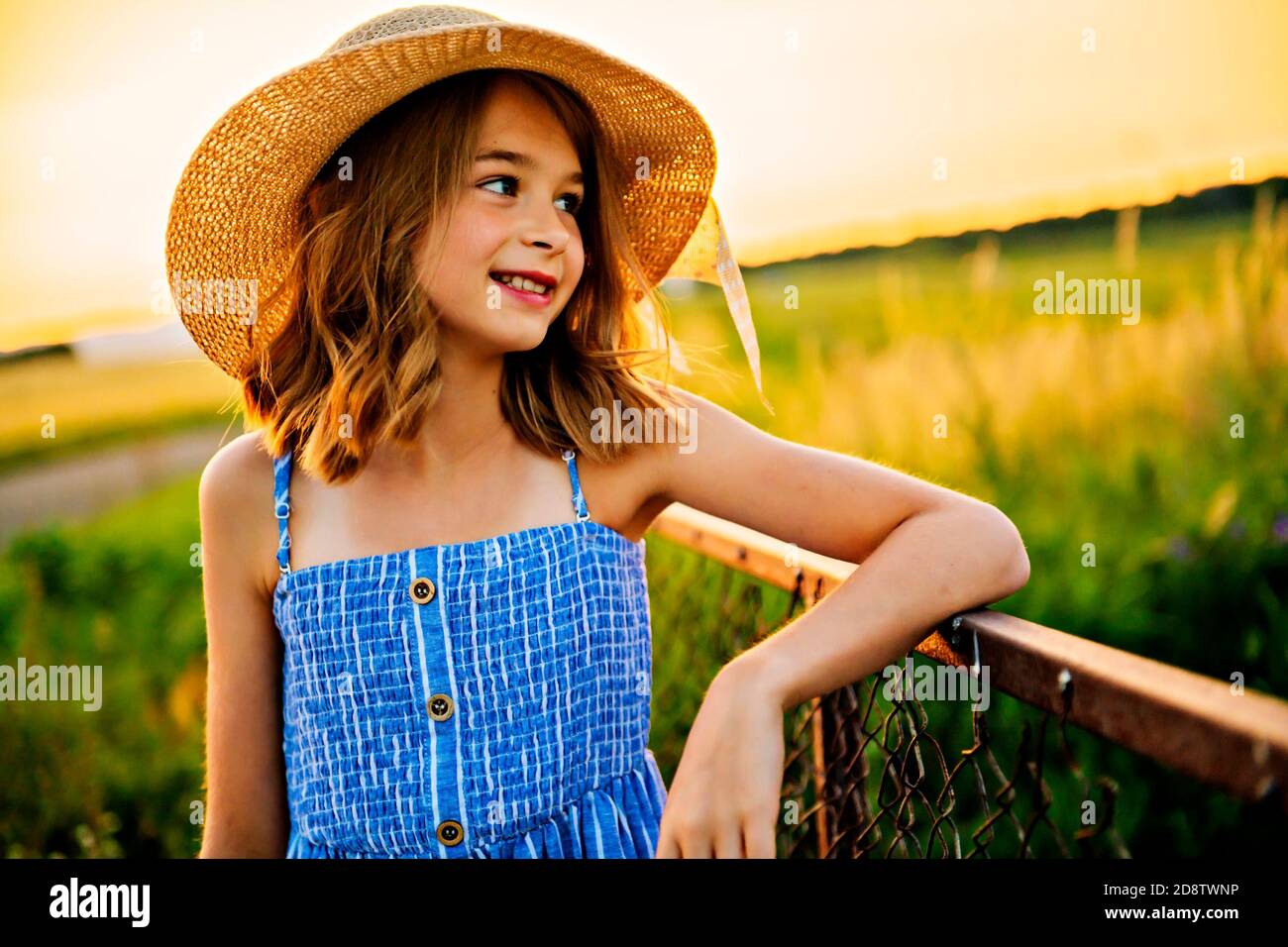 Child girl on a hay field at the sunset Stock Photo - Alamy