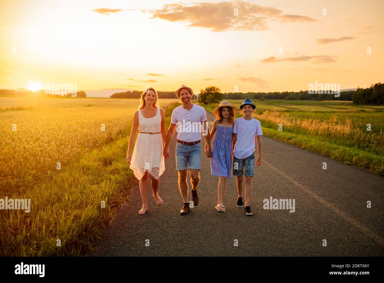 happy family at sunset. They having fun and playing in nature at sunset ...