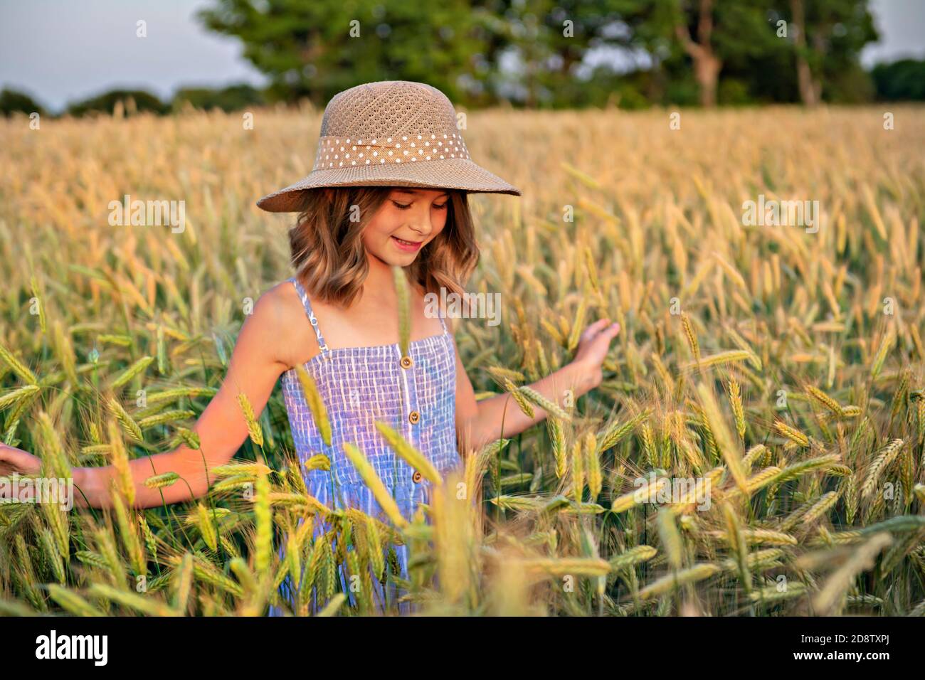 Child girl on a hay field at the sunset Stock Photo - Alamy