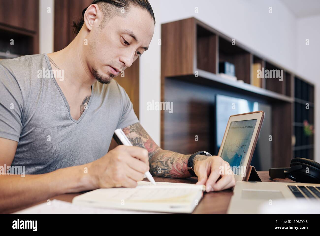 Entrepreneur writing down plans Stock Photo - Alamy