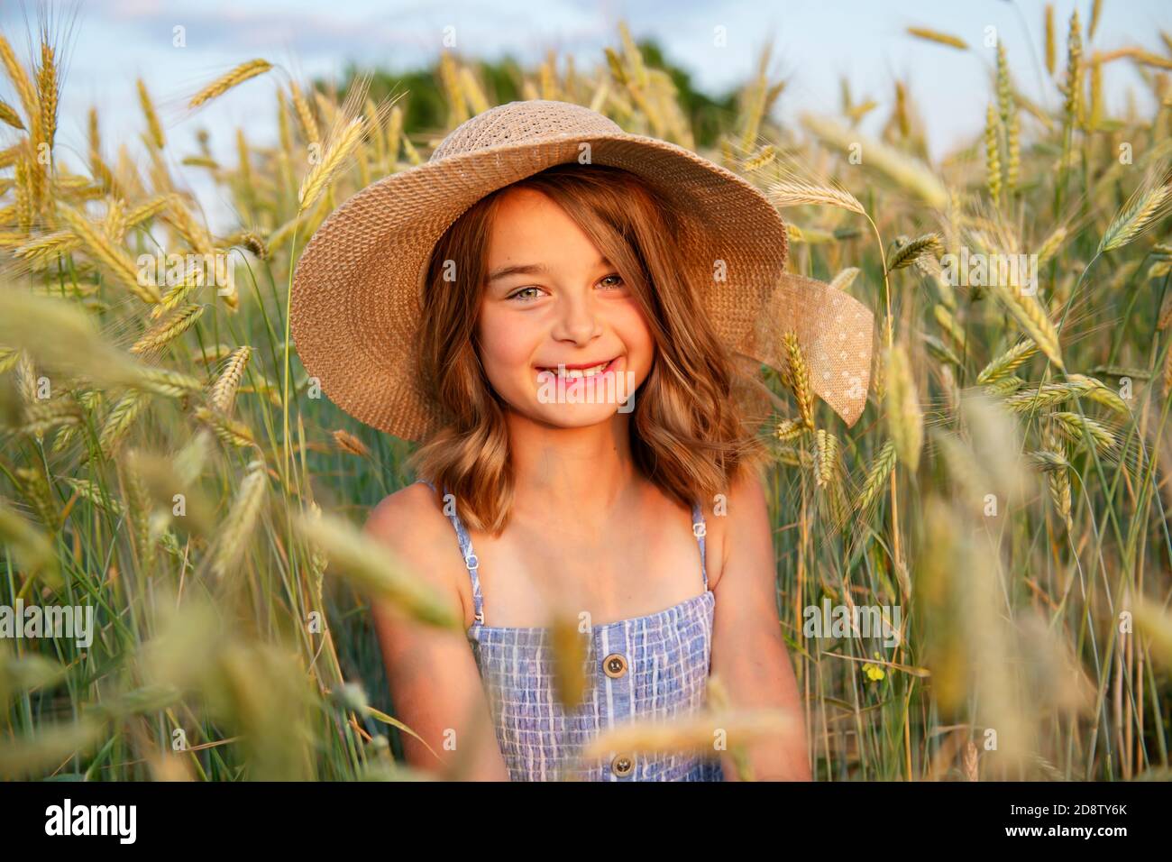 Child girl on a hay field at the sunset Stock Photo - Alamy
