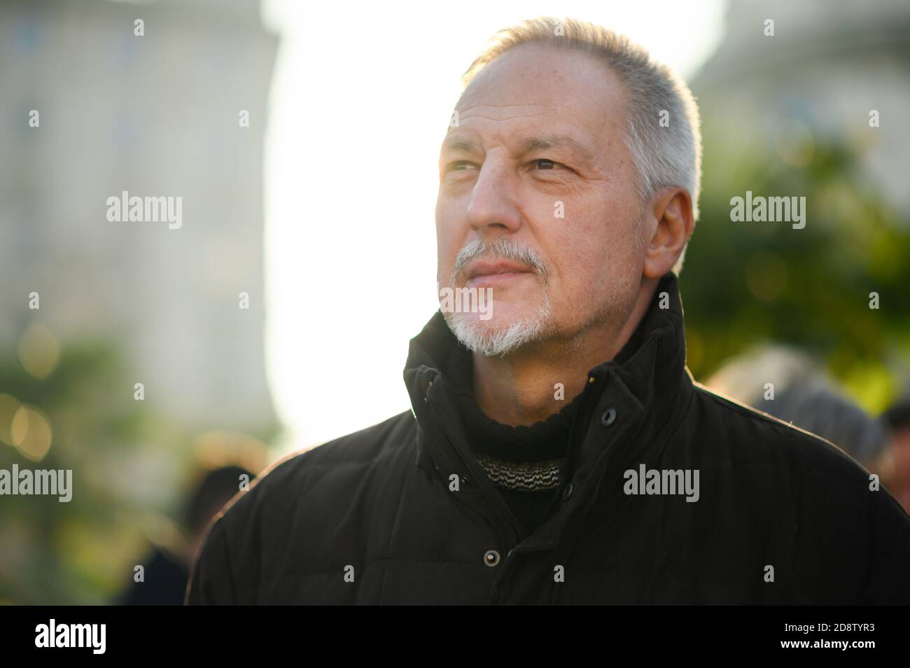 Mature man walking outdoor at backlight Stock Photo - Alamy