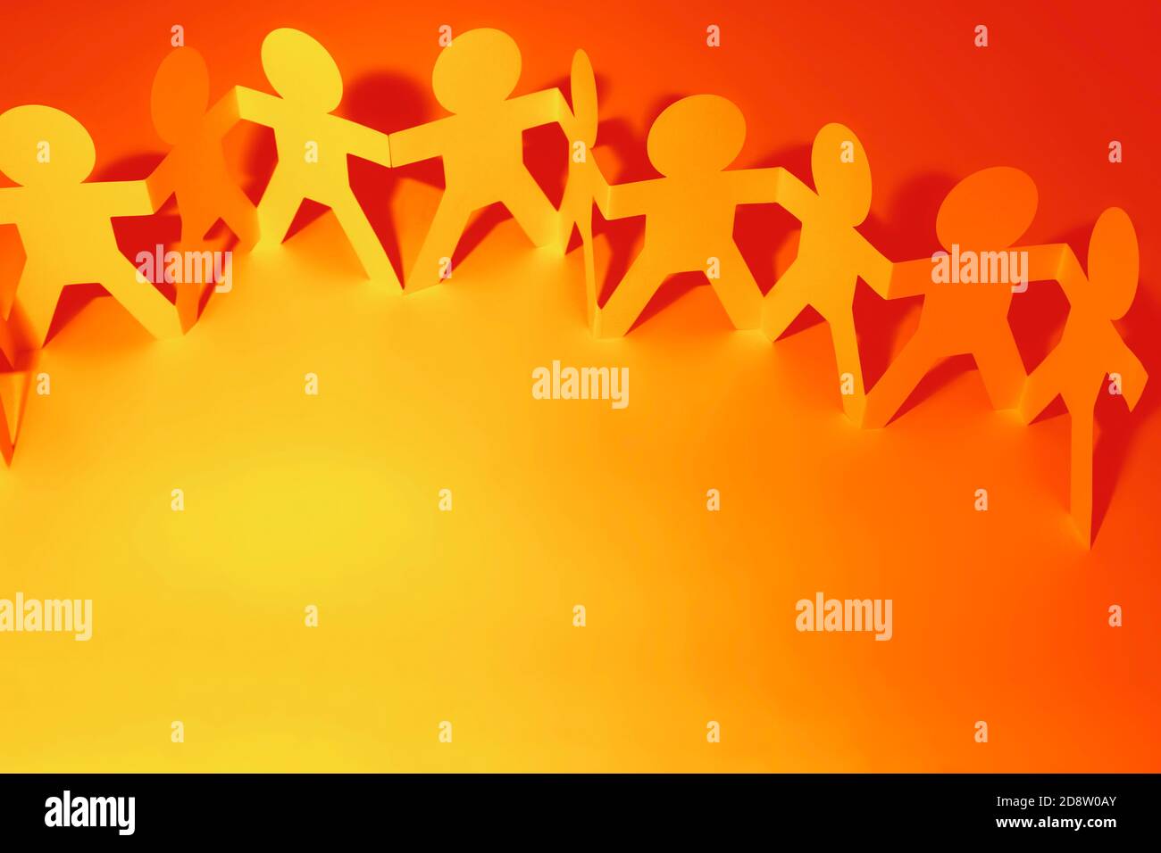 Paper chain team holding hands. Teamwork. Partnership Stock Photo - Alamy