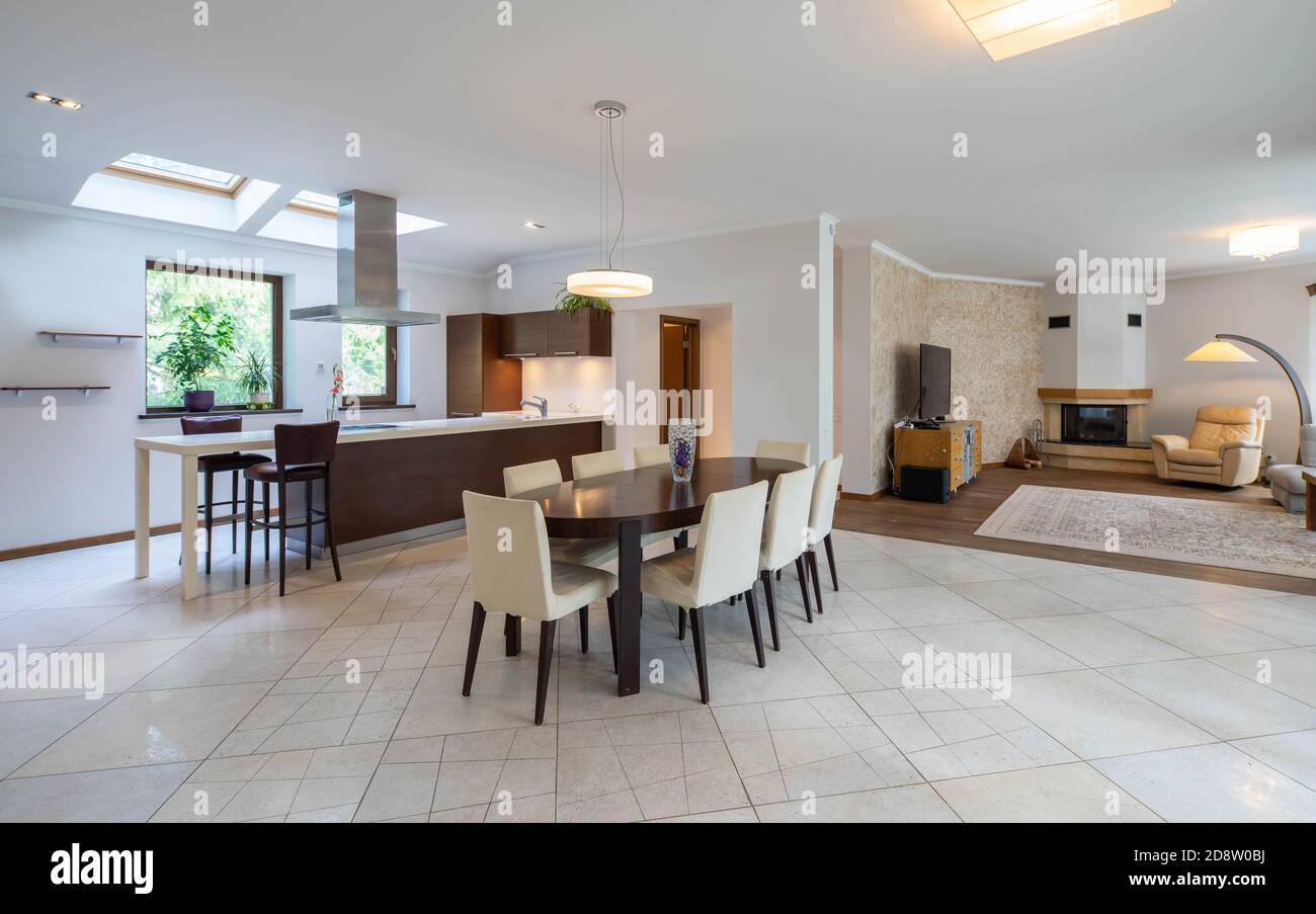 Modern interior of spacious luxury studio apartment. Wooden table and ...