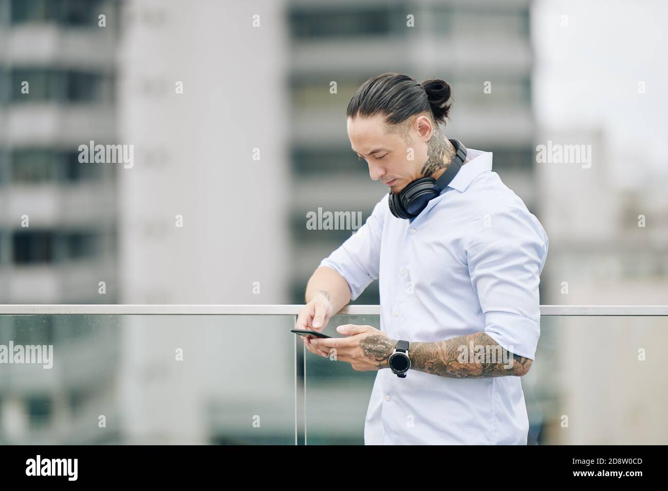 Serious man checking messages Stock Photo - Alamy