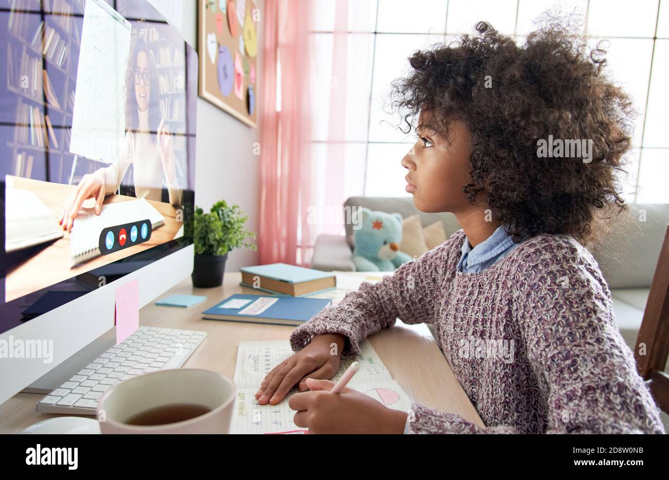 African school kid girl online learning with remote teacher at home on ...