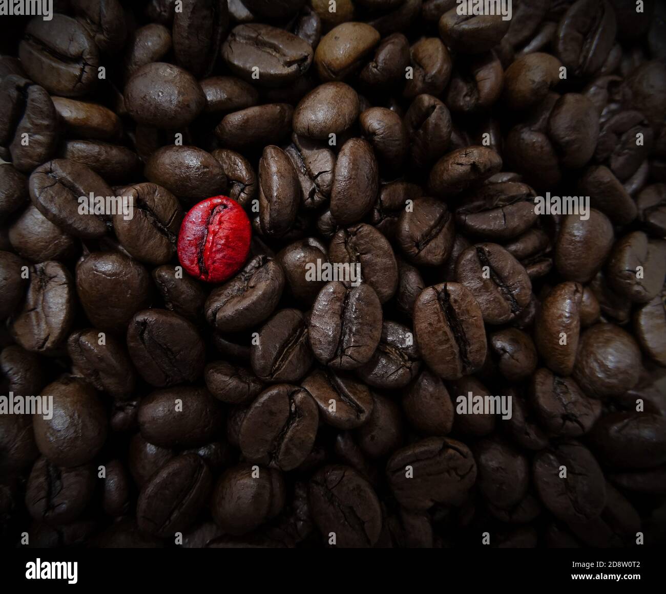 red coffee bean standing out from the others, be different, stand out ...