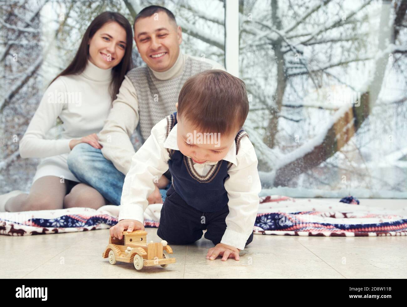 family playing at home. Dad, mom and son having fun with toy Stock ...