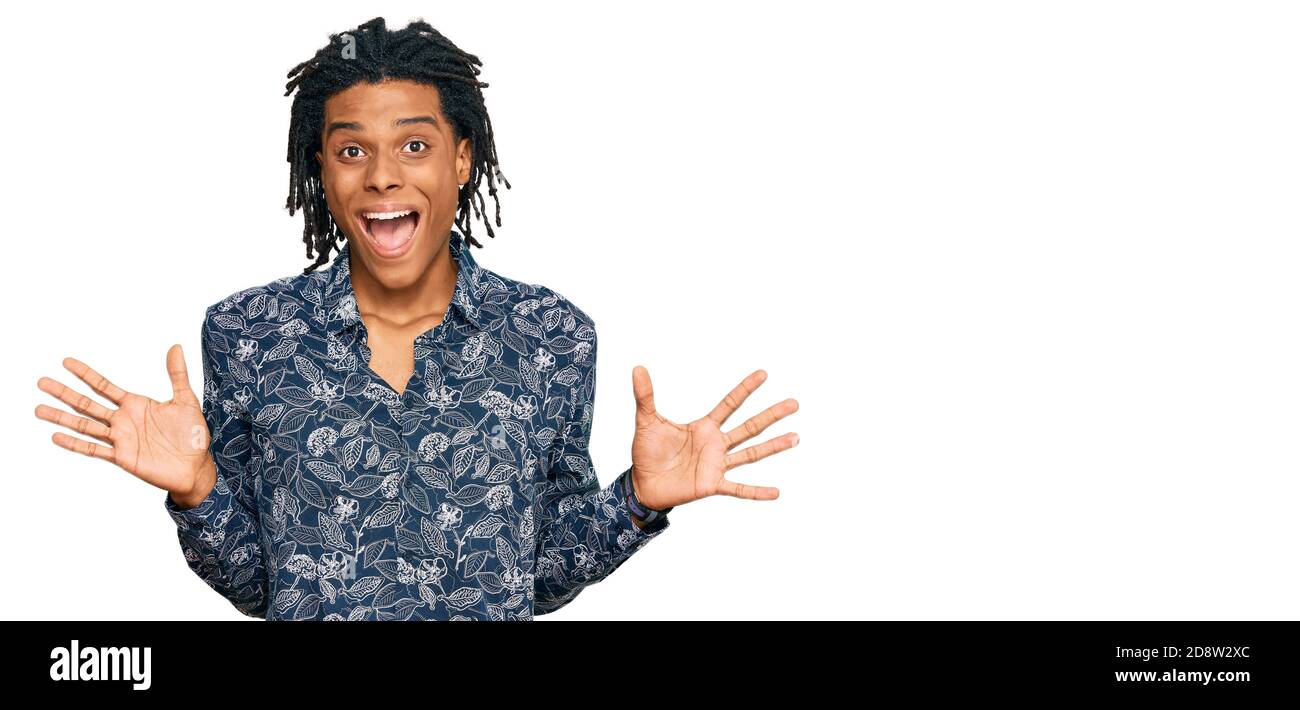 Young african american man wearing 80s shirt celebrating victory with ...