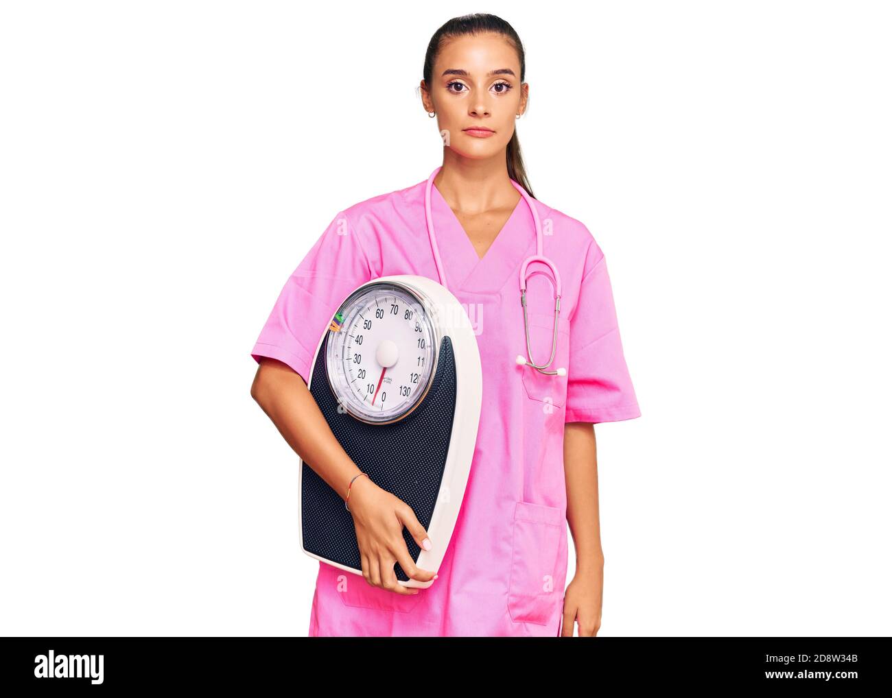 Young hispanic woman as nutritionist doctor holding weighing machine ...