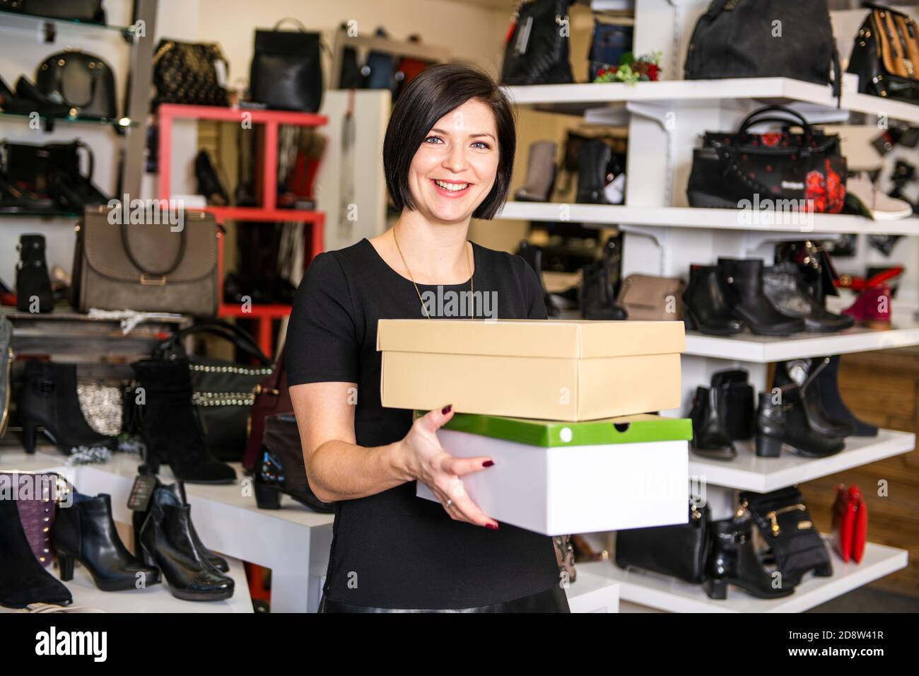 A sale, shopping and people concept happy young woman or shop assistant ...