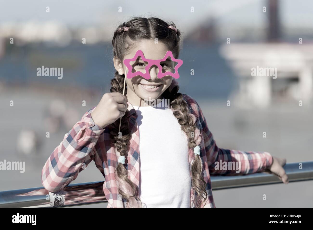 Aint it funny. Little girl looking through funny star shaped glasses on ...