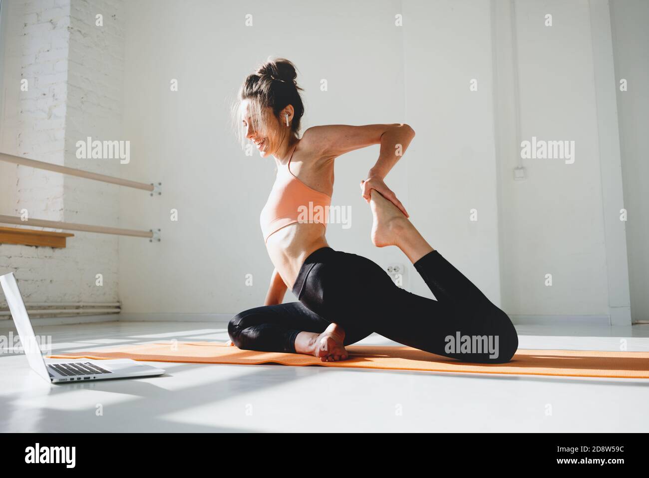 Remote yoga teacher having virtual yoga class using video call on ...