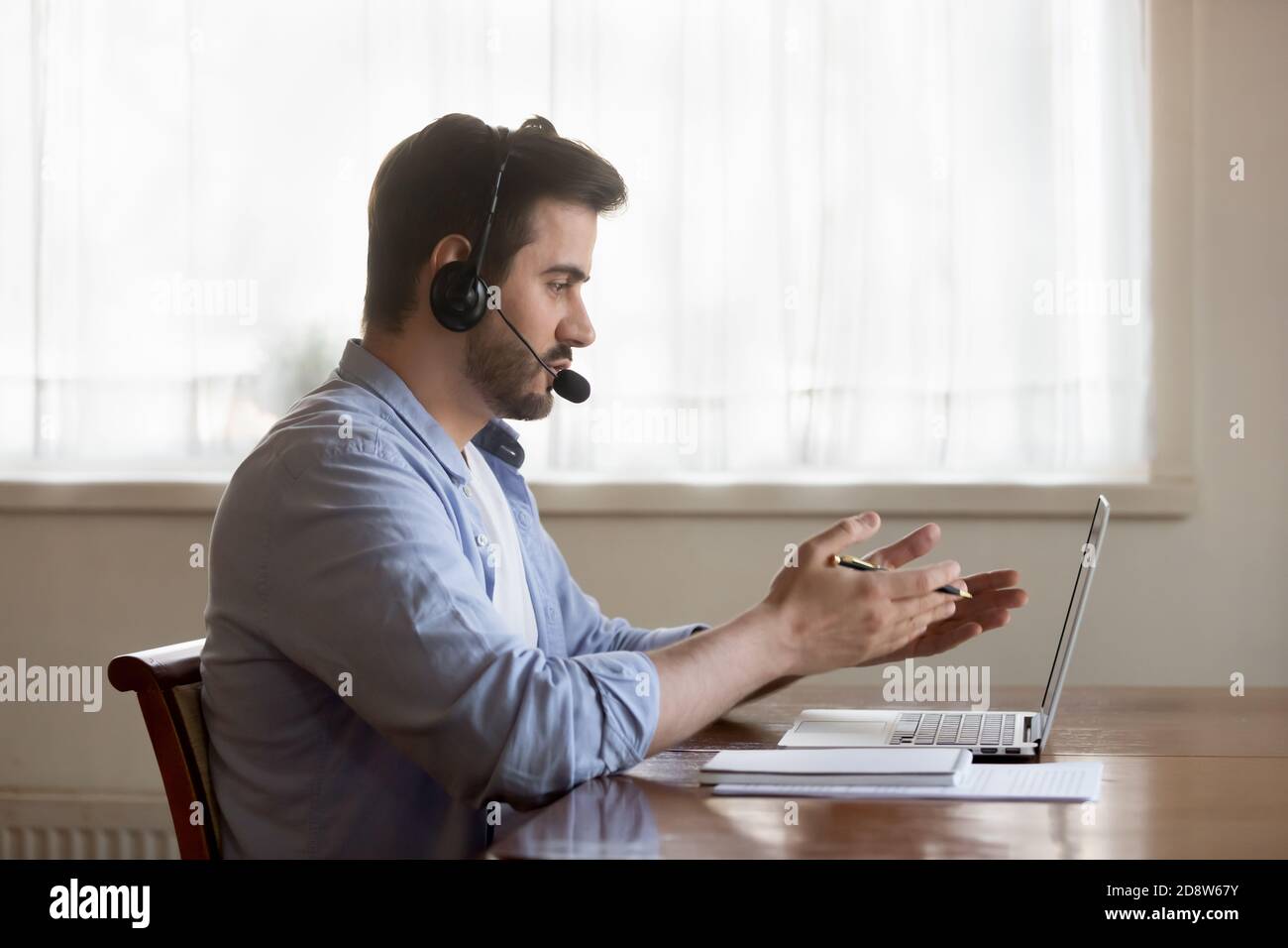 Capable young male teacher giving online lecture course Stock Photo - Alamy