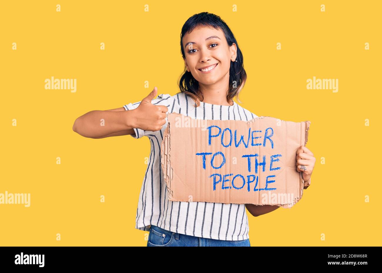 Young woman holding power to the people banner smiling happy and ...