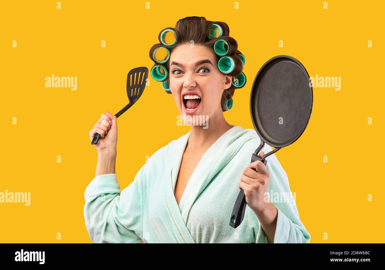 Crazy Housewife Raising Frying Pan Threatening And Screaming, Yellow ...