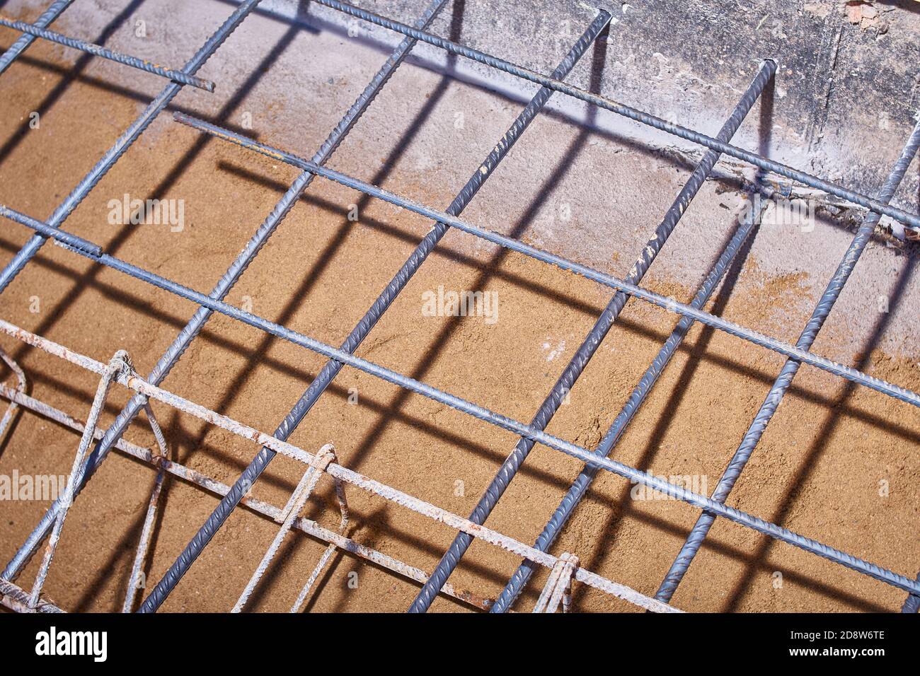 Corrugated iron of different sizes to make a grid in a concrete floor ...